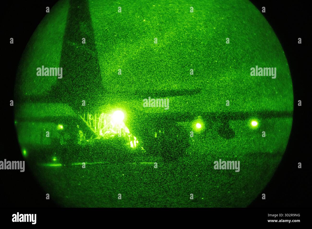 A U.S. Air Force C-130 Hercules crew offloads cargo during a night ...