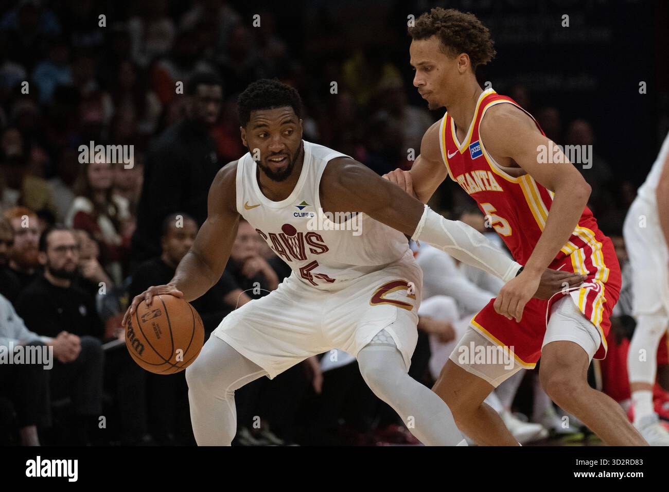 Cleveland Cavaliers' Donovan Mitchell, left, protects the ball from Atlanta Hawks' Dyson Daniels ...