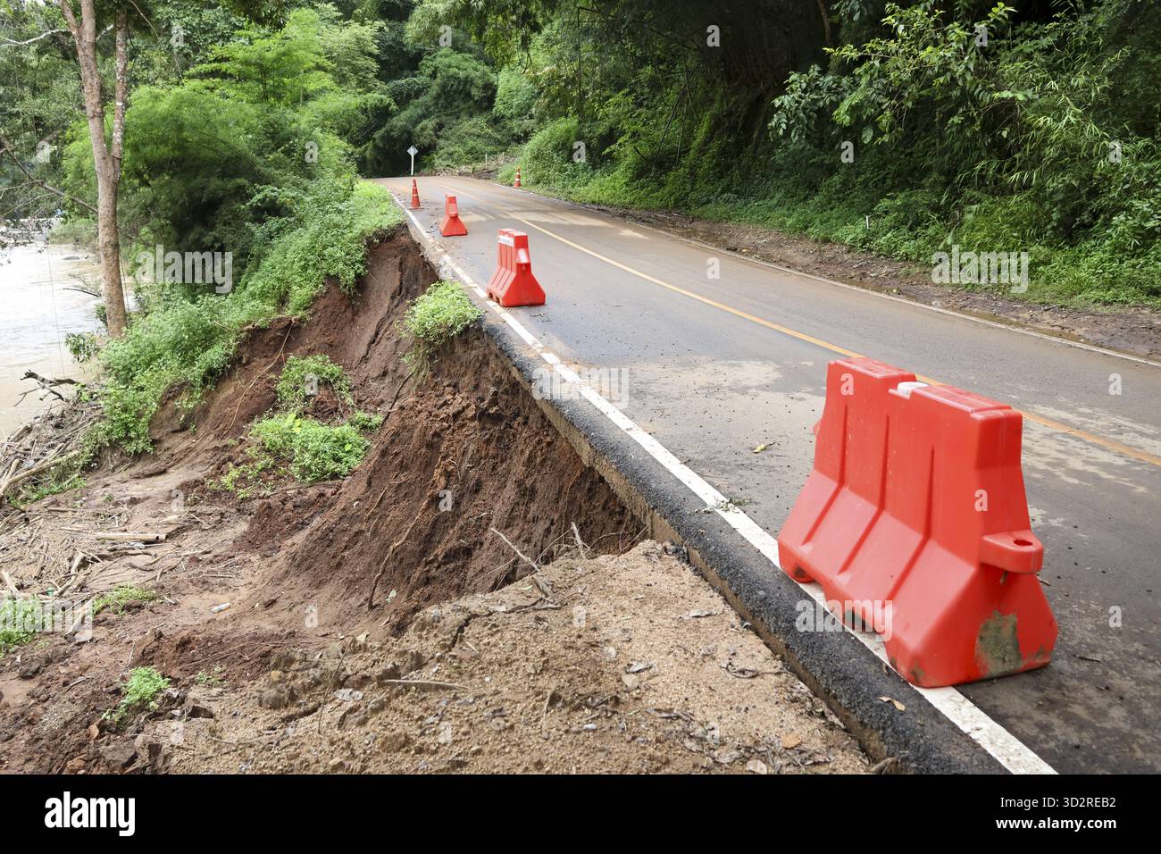 Dangerous landslide causing road damage with soil erosion collapsing ...