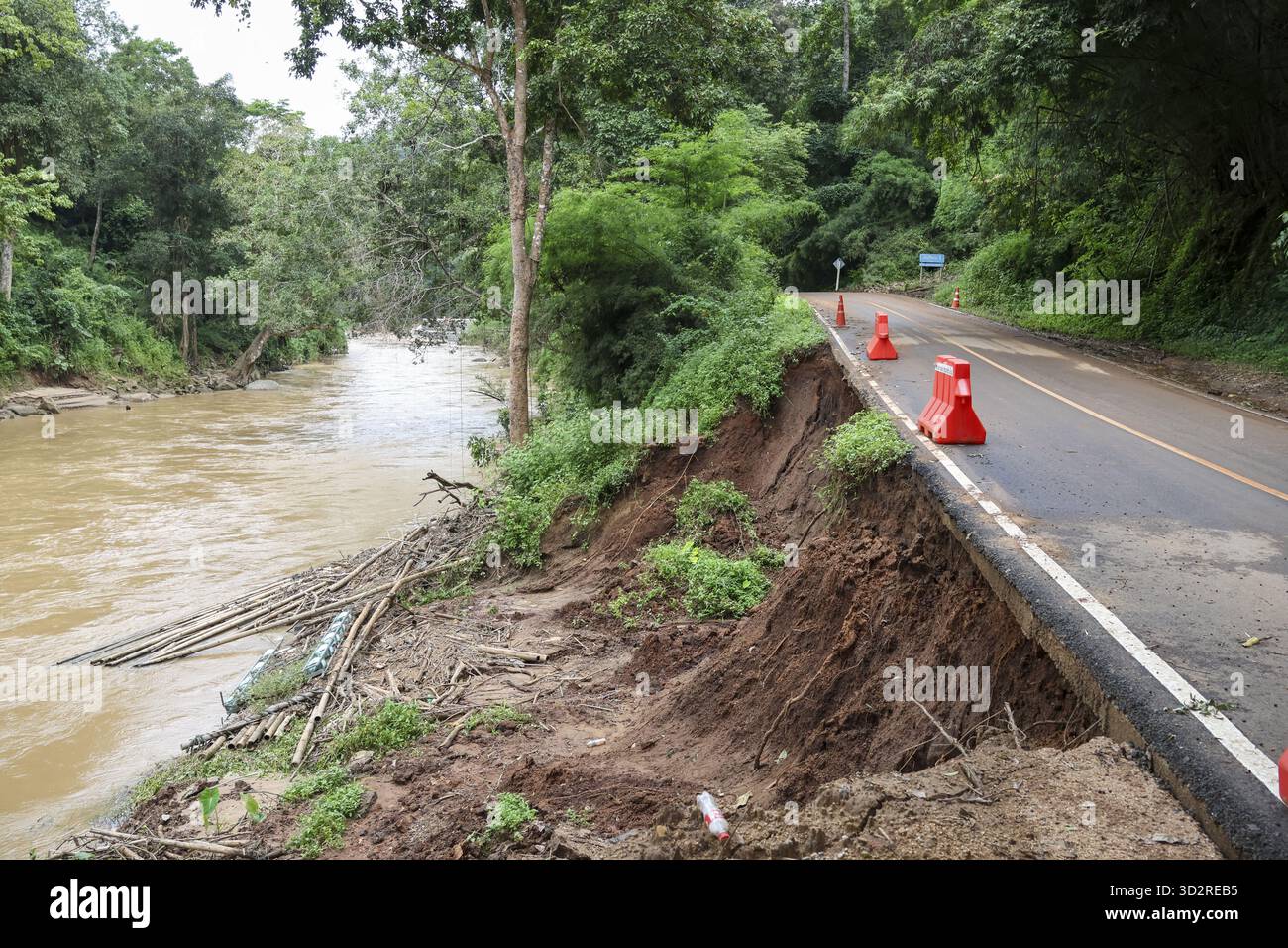 Dangerous road damaged by landslide and erosion from flooding river in ...