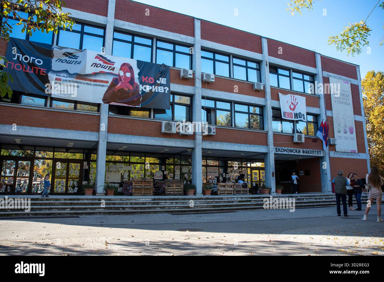 Two banners hang from the front of the university building of the ...