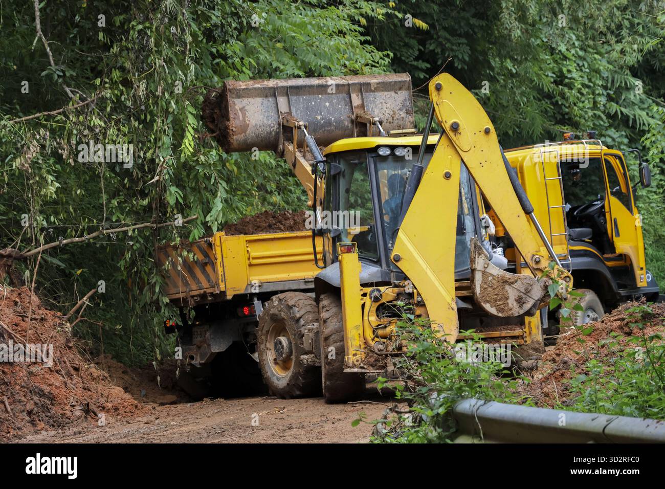 Yellow backhoe loader clearing hi-res stock photography and images - Alamy