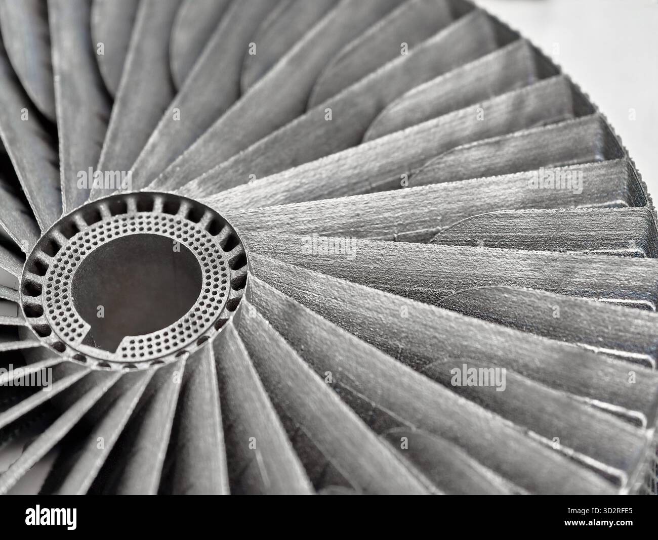 Close view of intricate metal part produced through additive ...