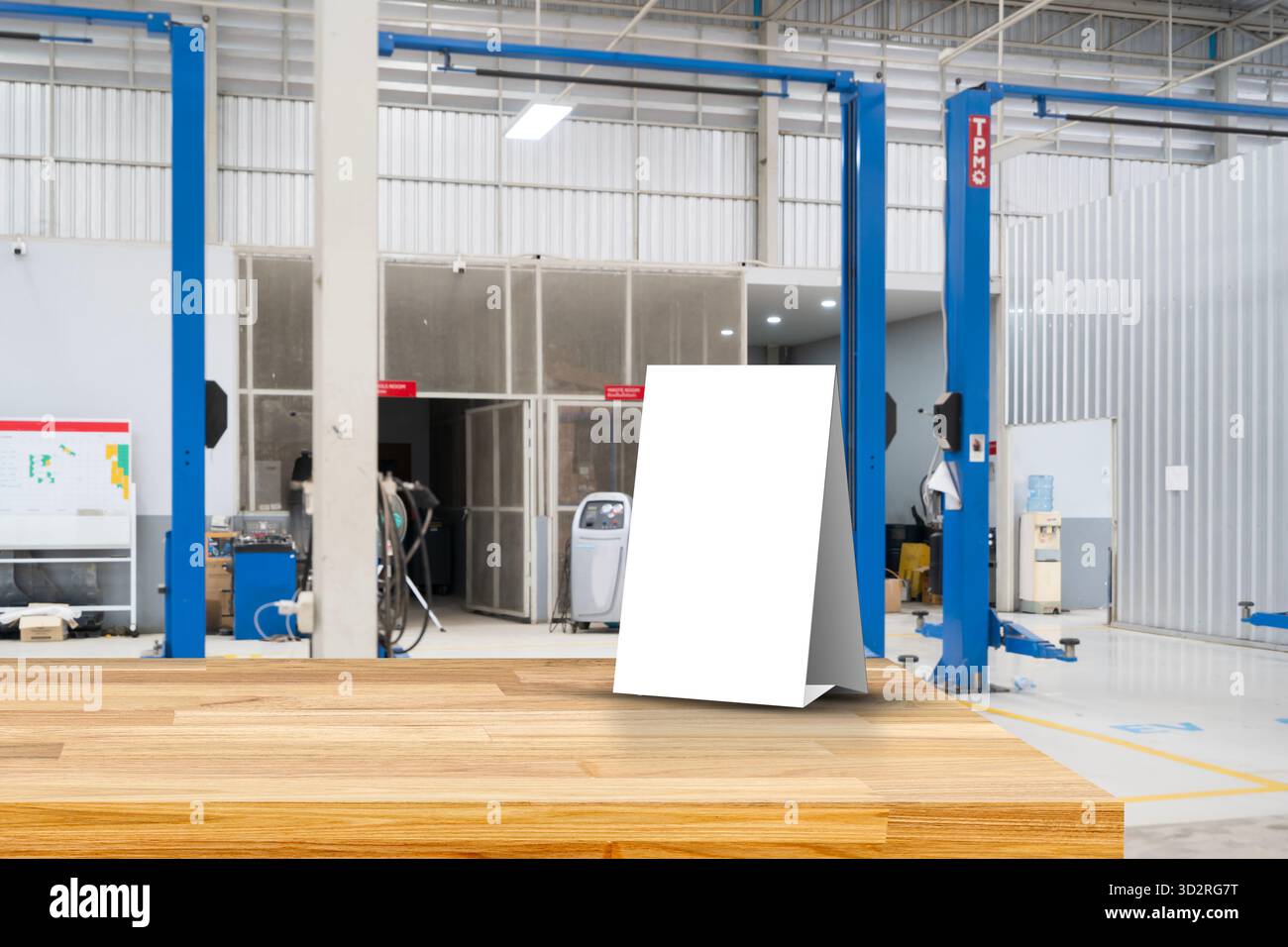 Empty white paper tent card standing on wooden table in automotive ...