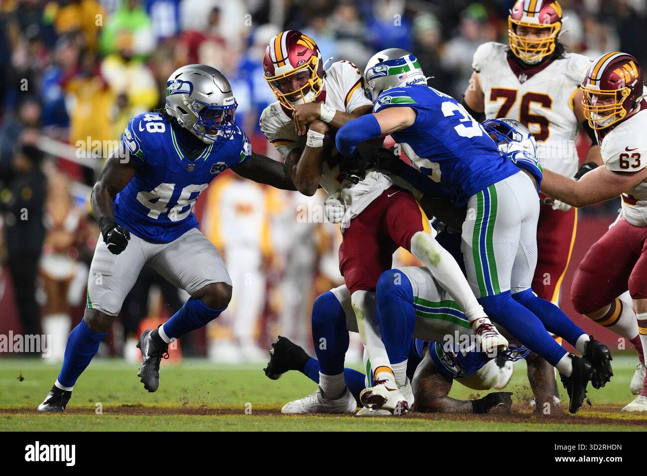Washington Commanders quarterback Jayden Daniels (5) is tackled by ...