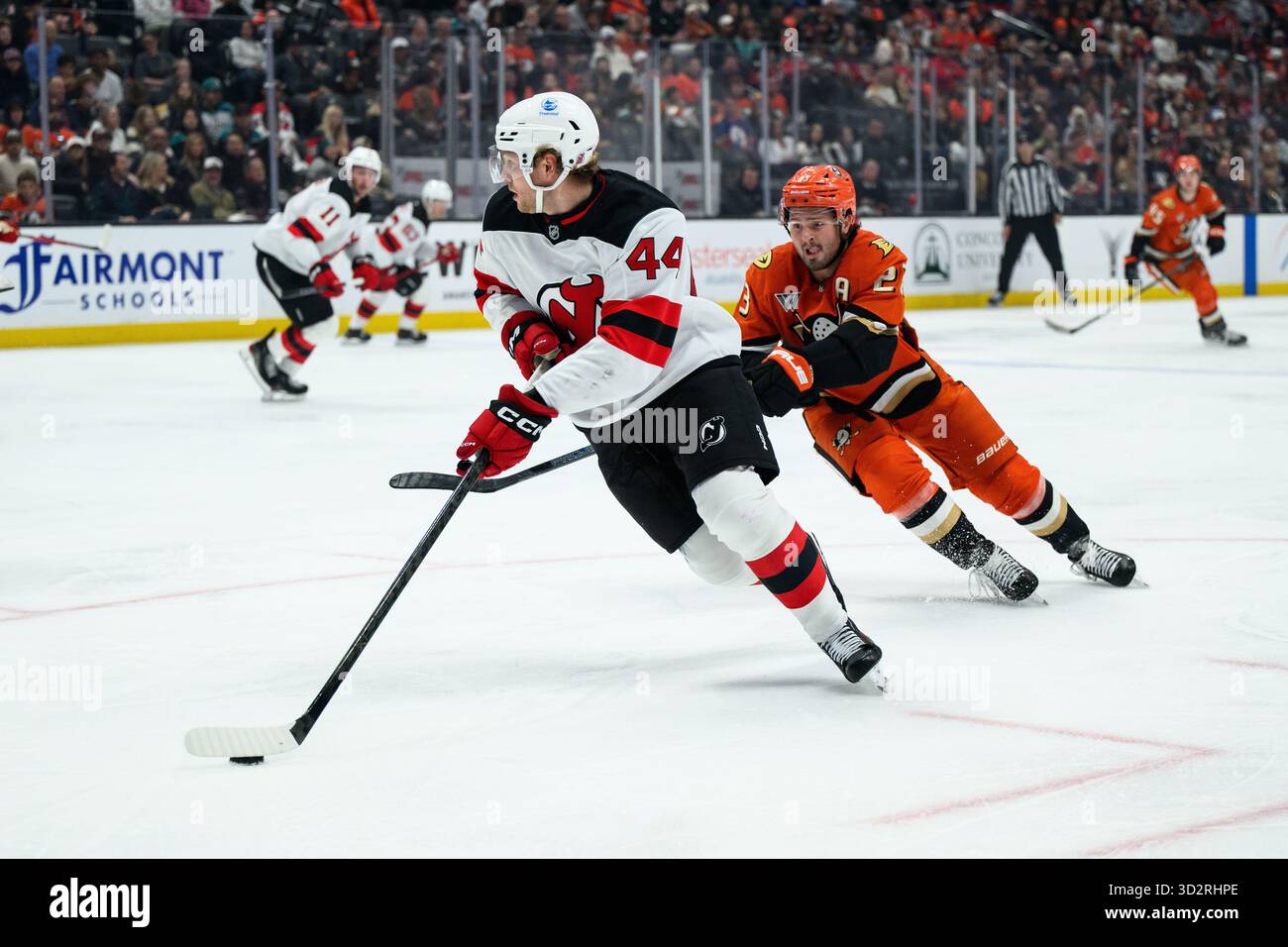 New Jersey Devils defenseman Dennis Cholowski, left, looks to shoot ...