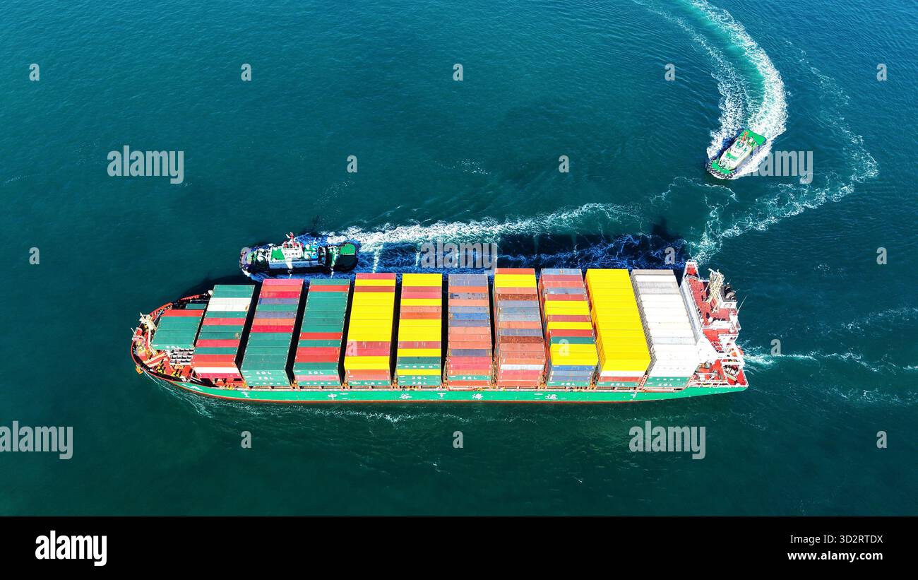 A cargo ship loaded with containers enters Qingdao Port, Qingdao City ...