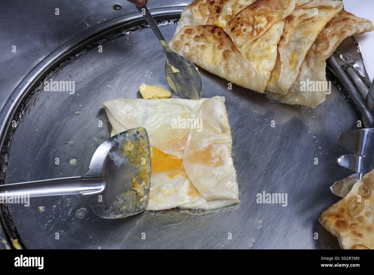 Chef cooking golden crispy Roti, popular Asian street food. flatbread ...