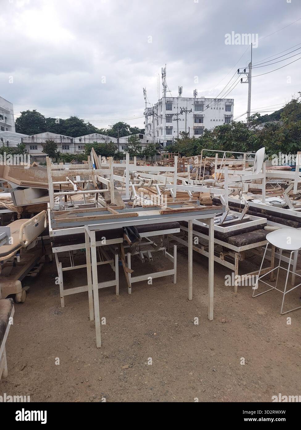 Pile of old, abandoned furniture, including broken chairs and tables ...