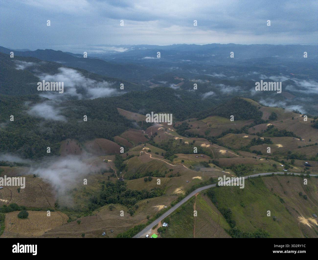 Aerial landscape showcases mountain hill and valley forms. winding road ...