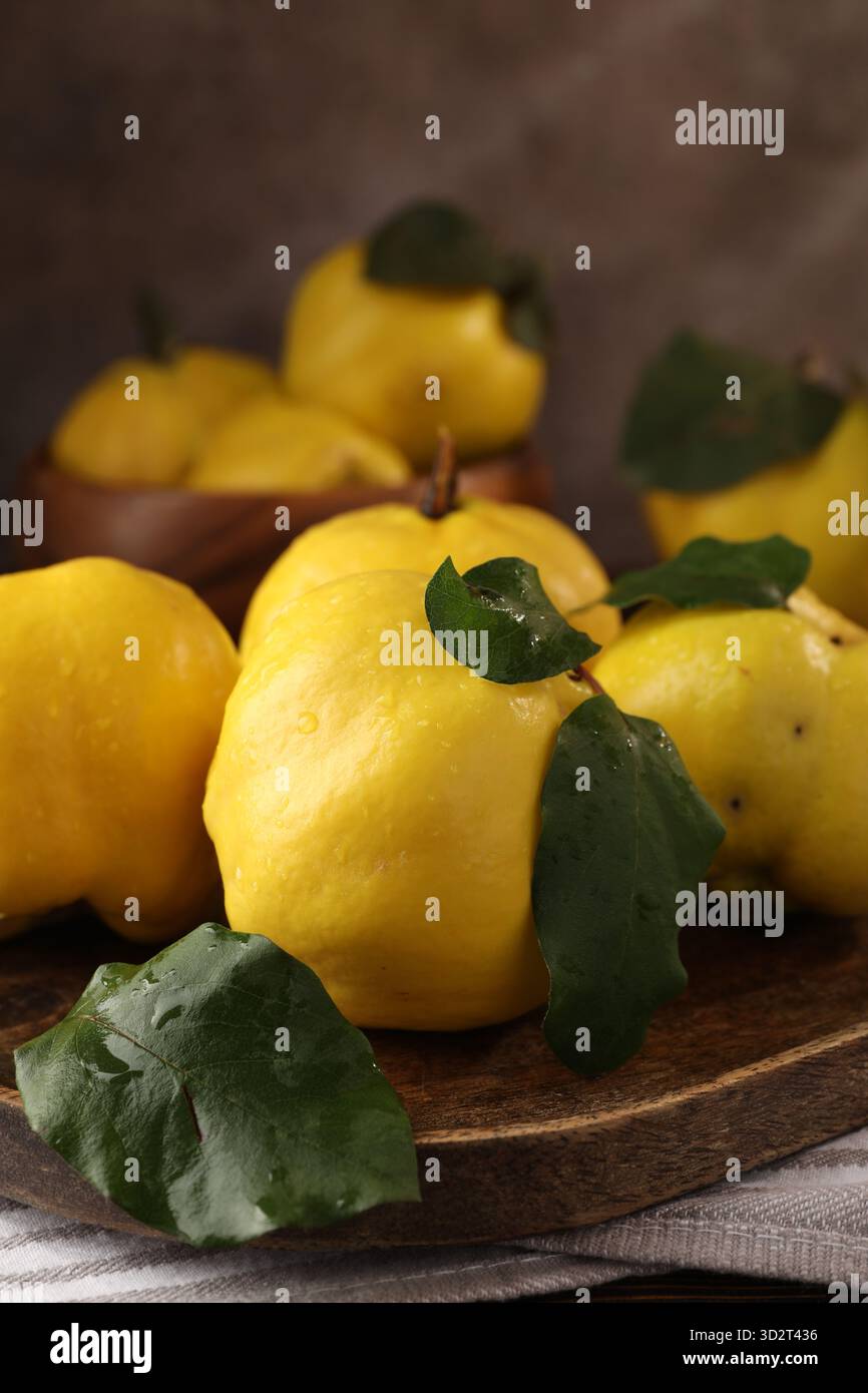 Fresh ripe quinces with leaves on table, closeup Stock Photo - Alamy