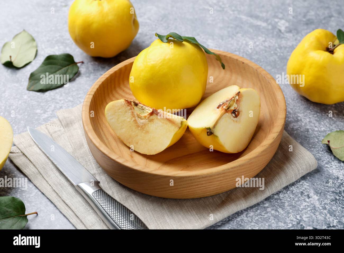 Ripe quinces and knife on grey table, closeup Stock Photo - Alamy