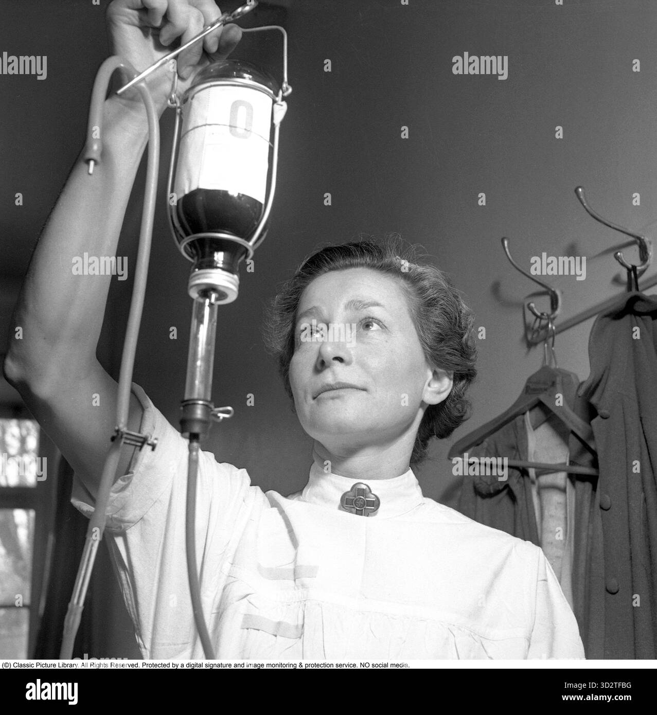 Blood transfusion in the 1950s. A nurse wearing a Sophiahemmet badge on ...