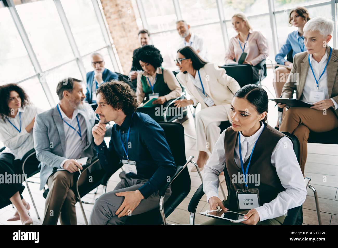 Team members attending a modern workplace meeting discussing ideas and ...