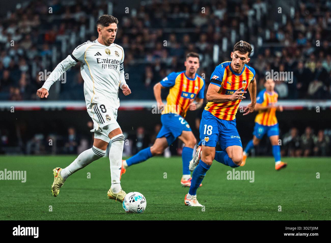 Fede Valverde of Real Madrid running with the ball with Jose Luis ...