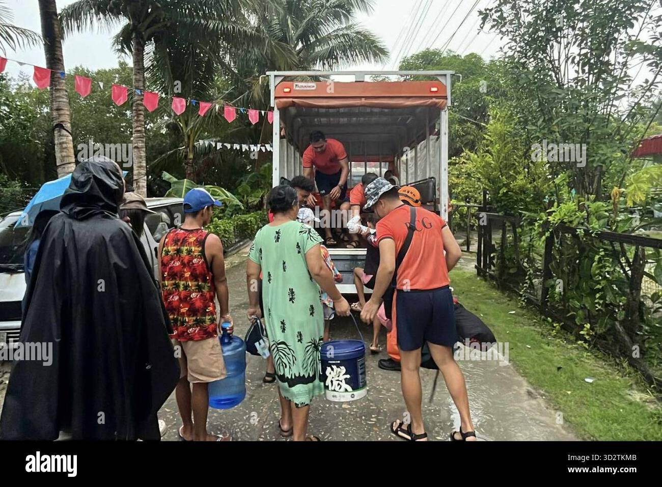 In this photo, provided by the Philippine Coast Guard, residents are ...