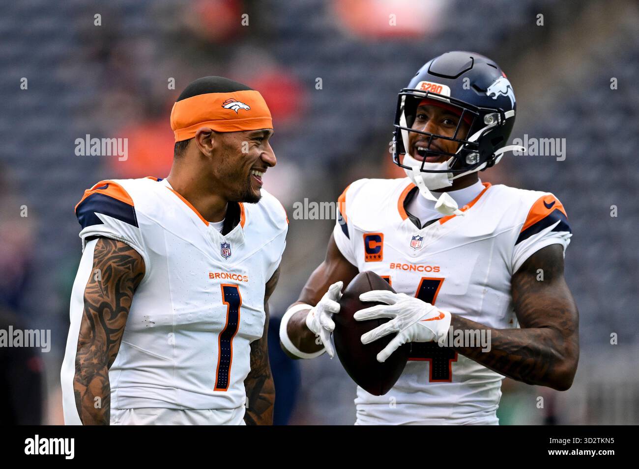 Denver Broncos tight end Evan Engram (1) speaks with wide receiver ...