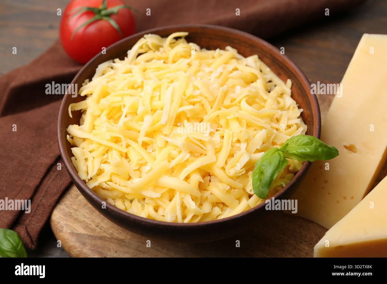 Grated and pieces of cheese on wooden table, closeup Stock Photo - Alamy