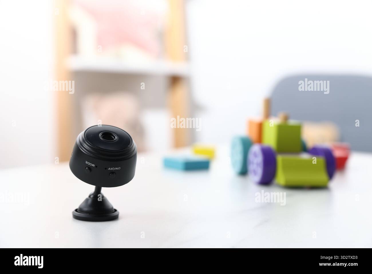Hidden spy camera on white table in child's room. Space for text Stock ...