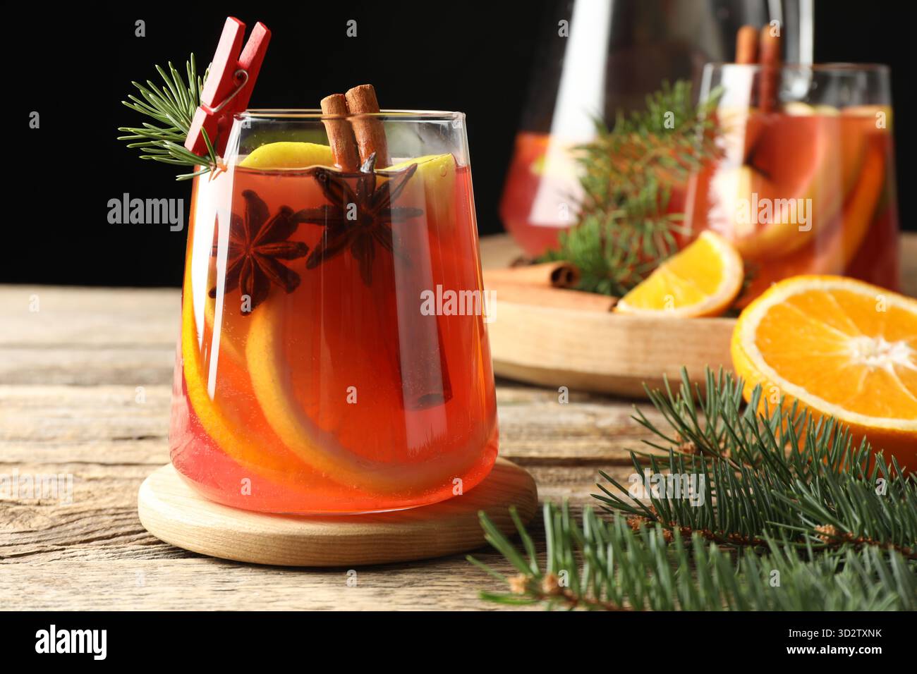 Tasty punch drink in glasses, jug, orange and Christmas decor on wooden ...