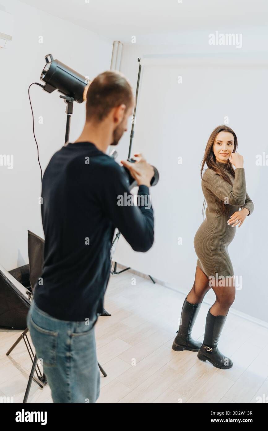 Photographer capturing a female model in a professional studio setting ...