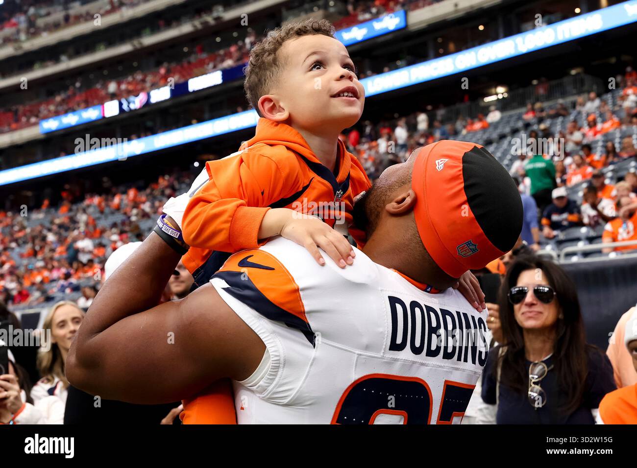 Denver Broncos running back J.K. Dobbins (27) holds his son prior to an ...