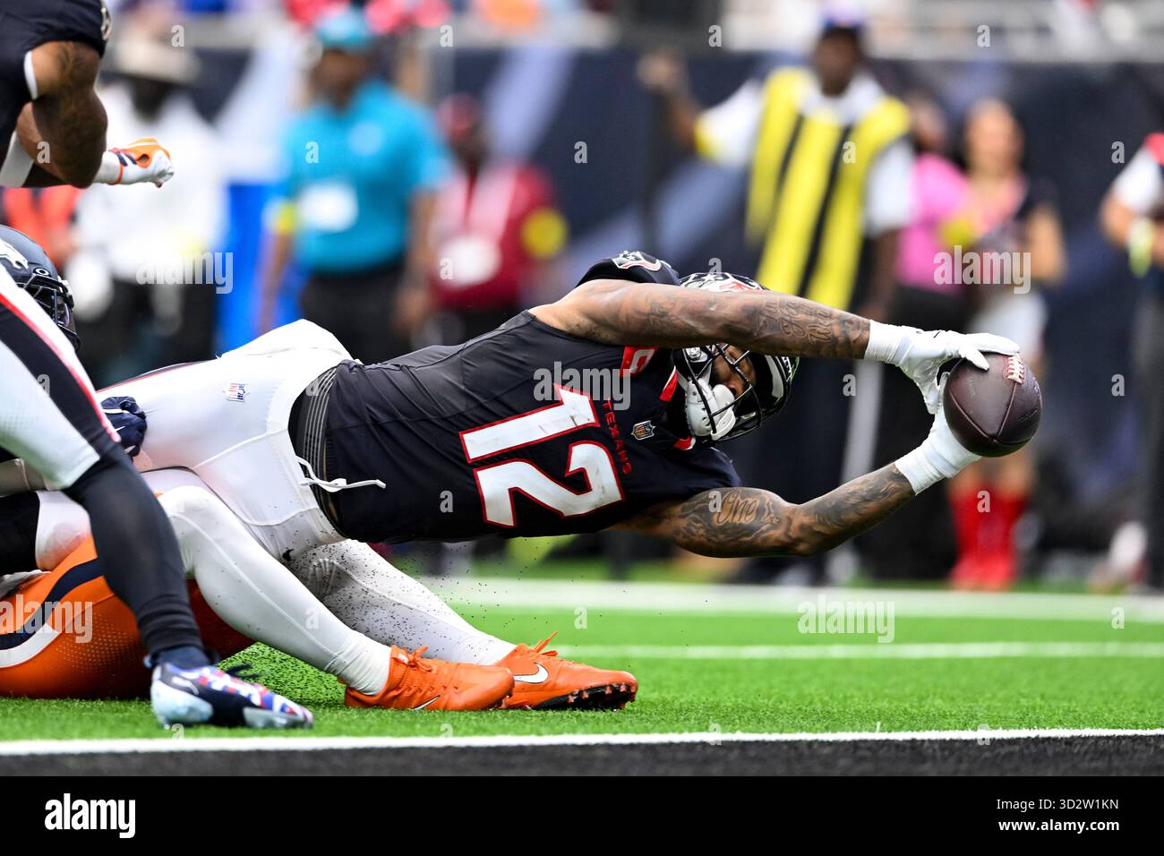 Houston Texans wide receiver Nico Collins (12) stretches for a first ...
