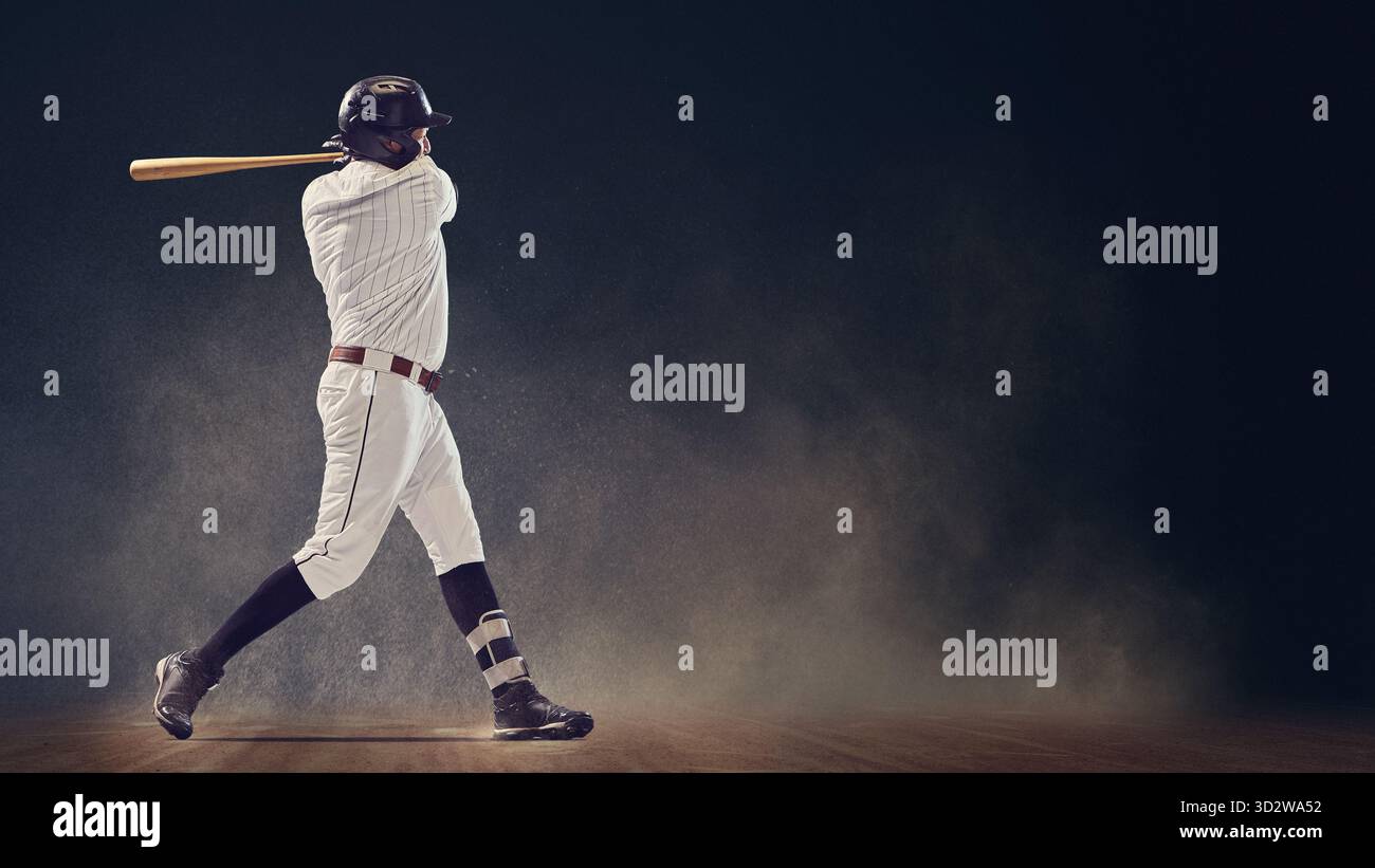 Baseball batter finishing powerful swing showing full body rotation and ...