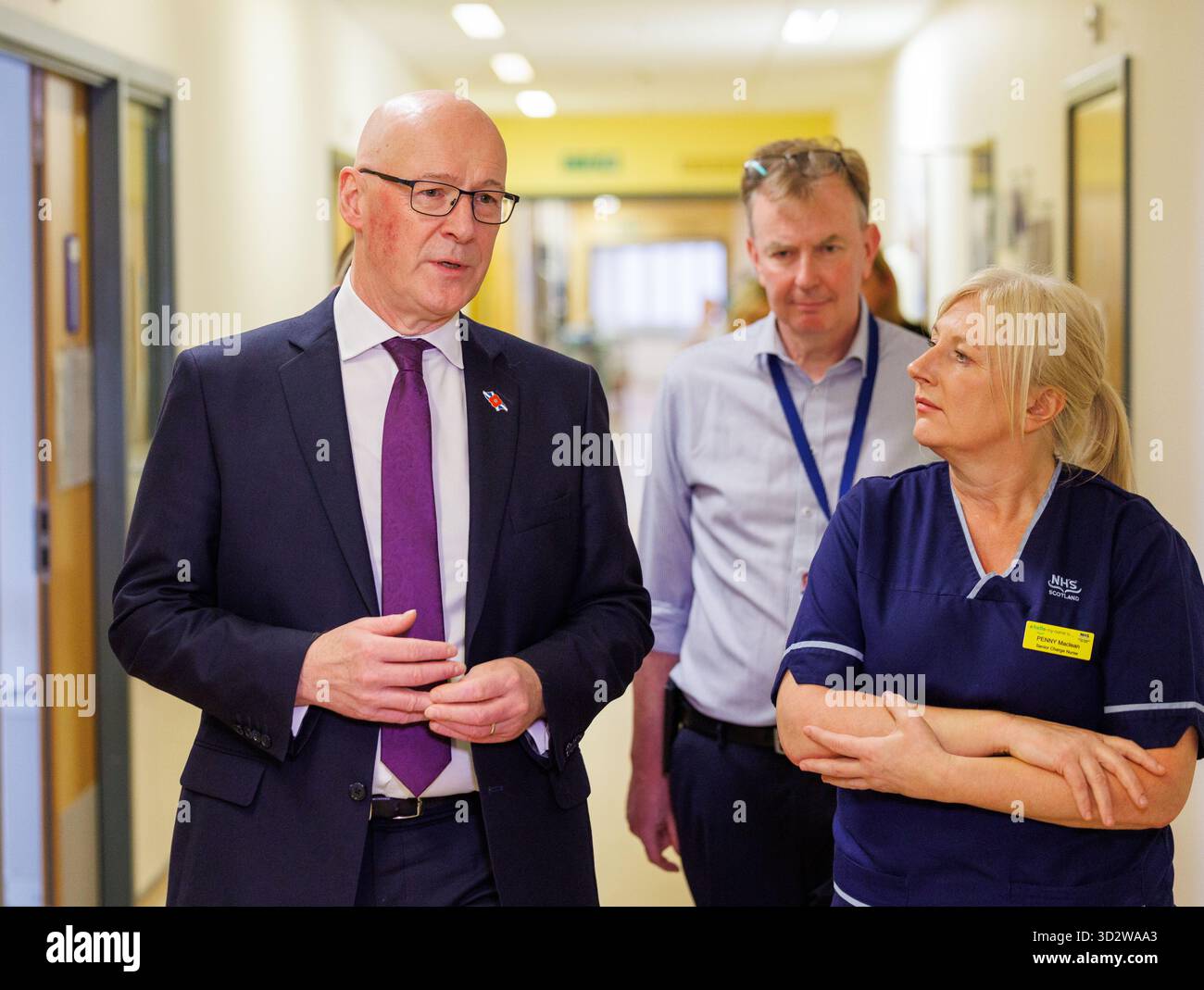 First Minister John Swinney with medical staff during a visit to Queen ...