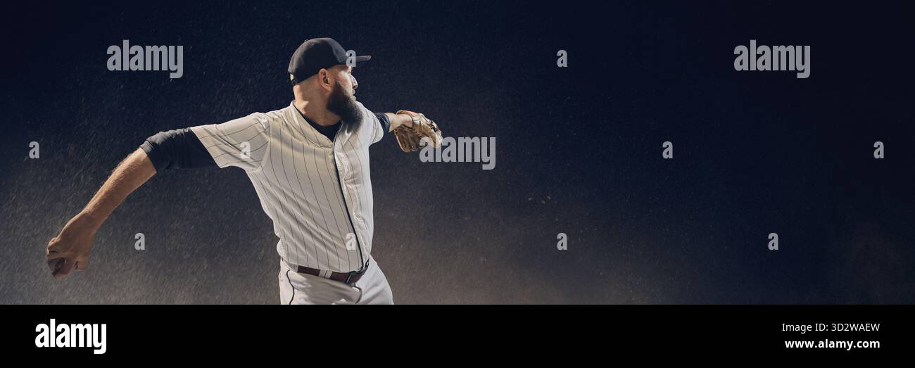 Baseball pitcher winding up before throw with dust particles floating ...
