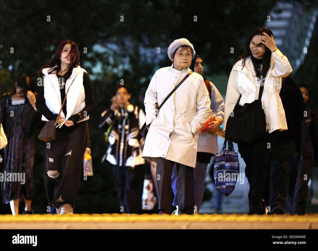 People walk through the streets in the cold in Minato Ward, Tokyo, on ...