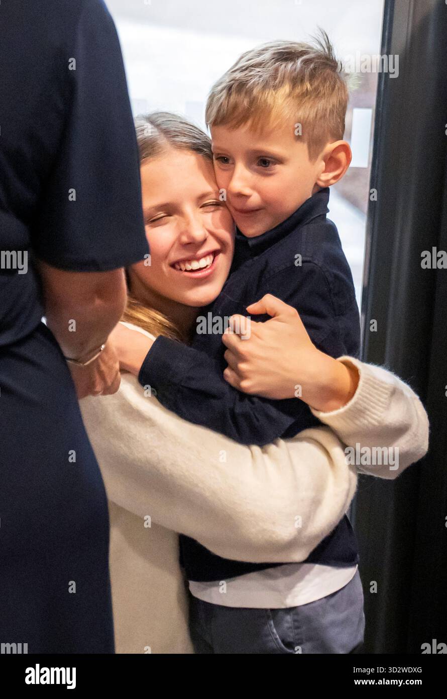 Macy Burrow embraces her brother Jackson Burrow after he cut the ribbon ...
