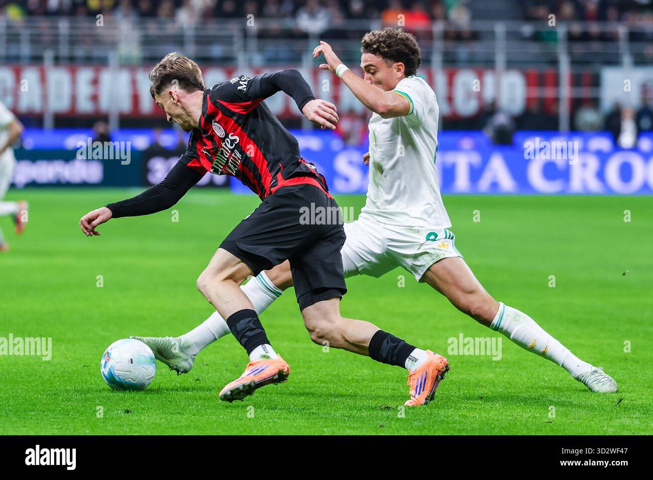 Alexis Saelemaekers of AC Milan competes for the ball with Neil Yoni El ...