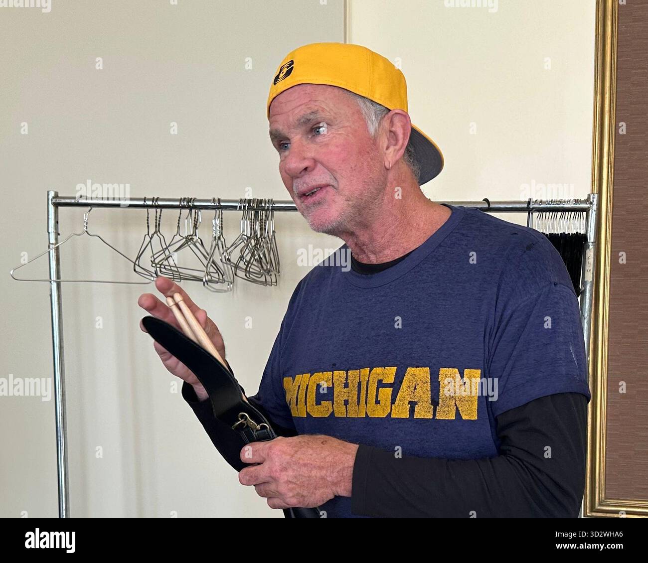 Red Hot Chili Peppers drummer Chad Smith holds a pair of drum sticks in ...