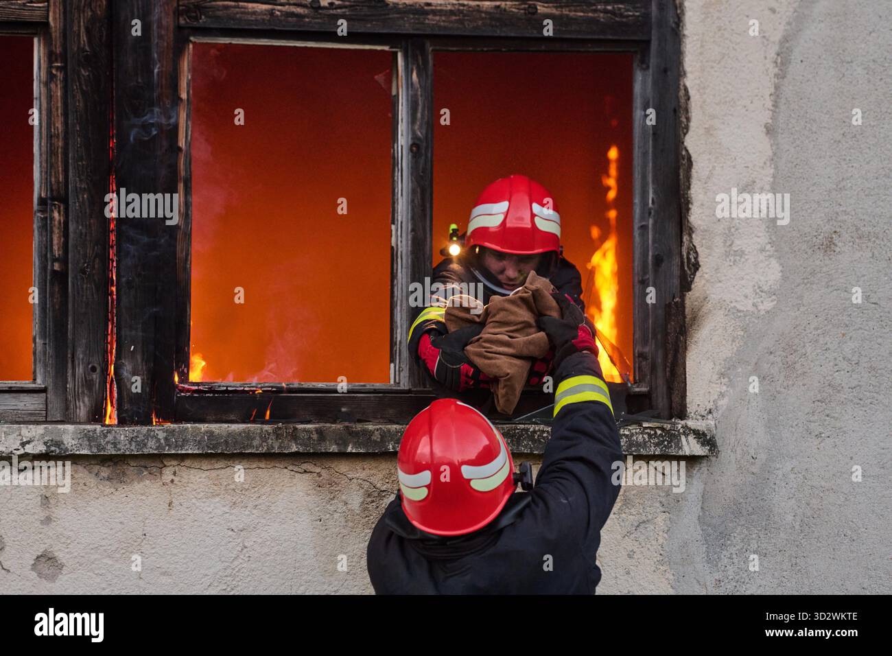 Firefighters battling flames in a burning building. This image can be ...