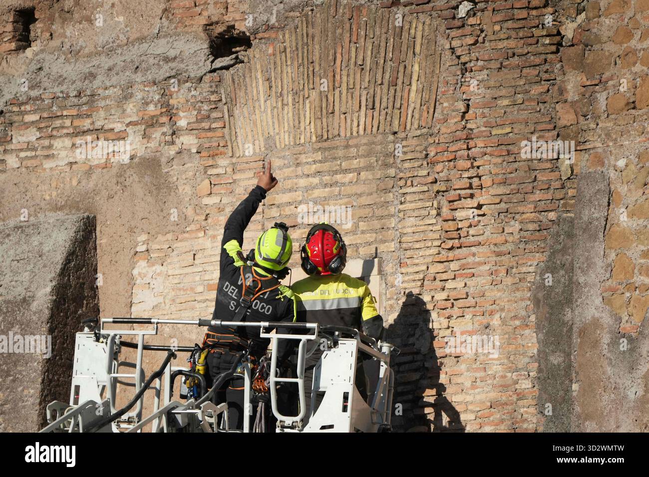 Firefighters work on a medieval tower Torre dei Conti near the Roman ...