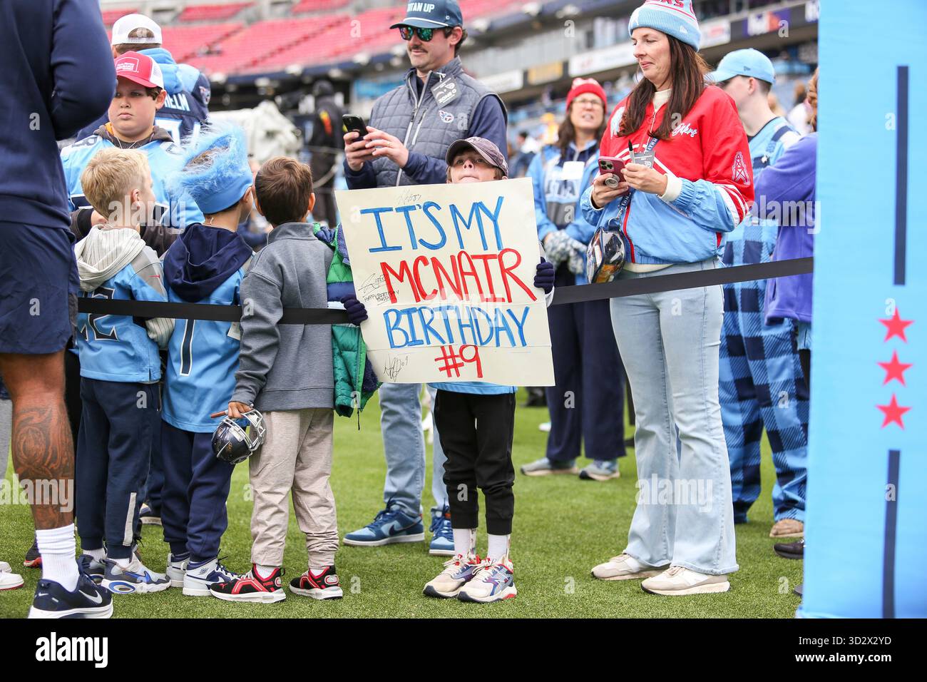 A young Titans fan holds up a sign celebrating their birthday and ...