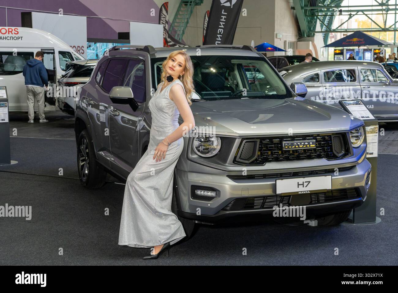 MINSK, BELARUS - OCTOBER 15, 2025: A woman poses next to a new Haval H7 ...