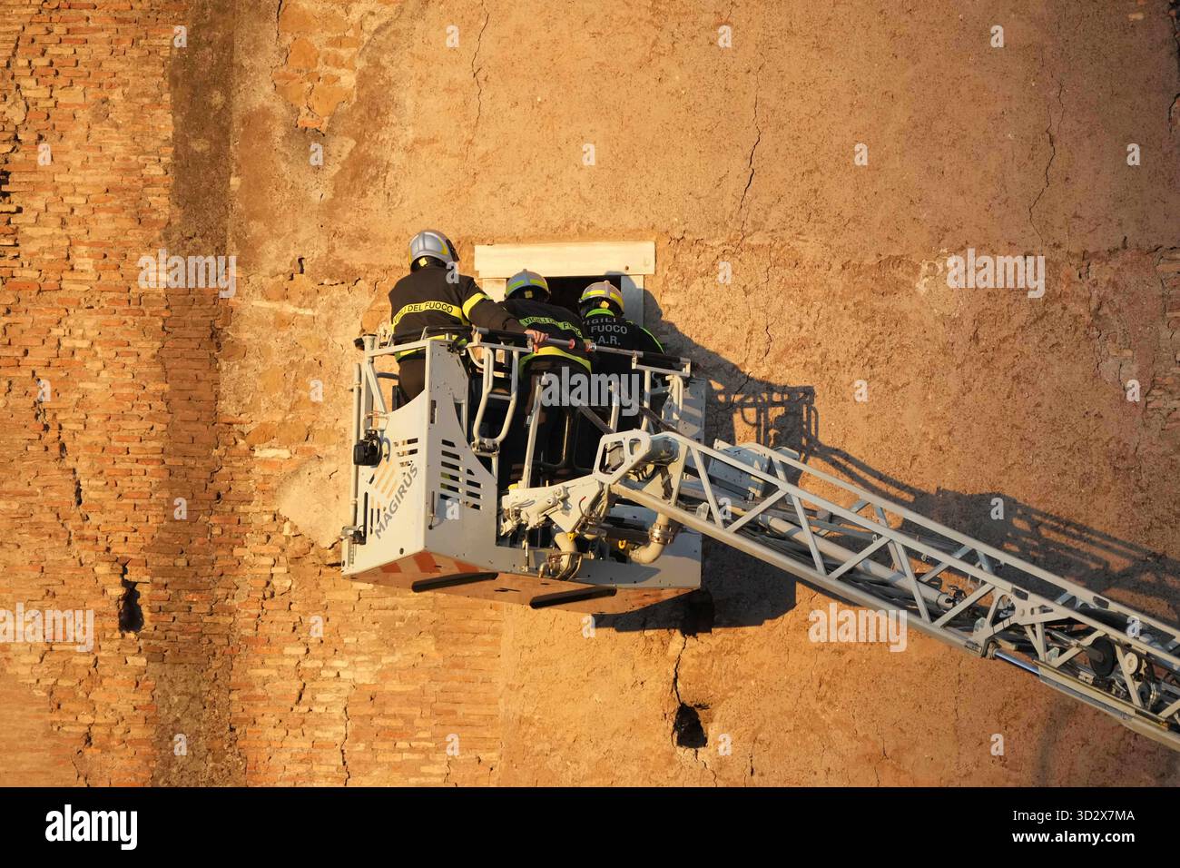 Firefighters work on a medieval tower Torre dei Conti near the Roman ...