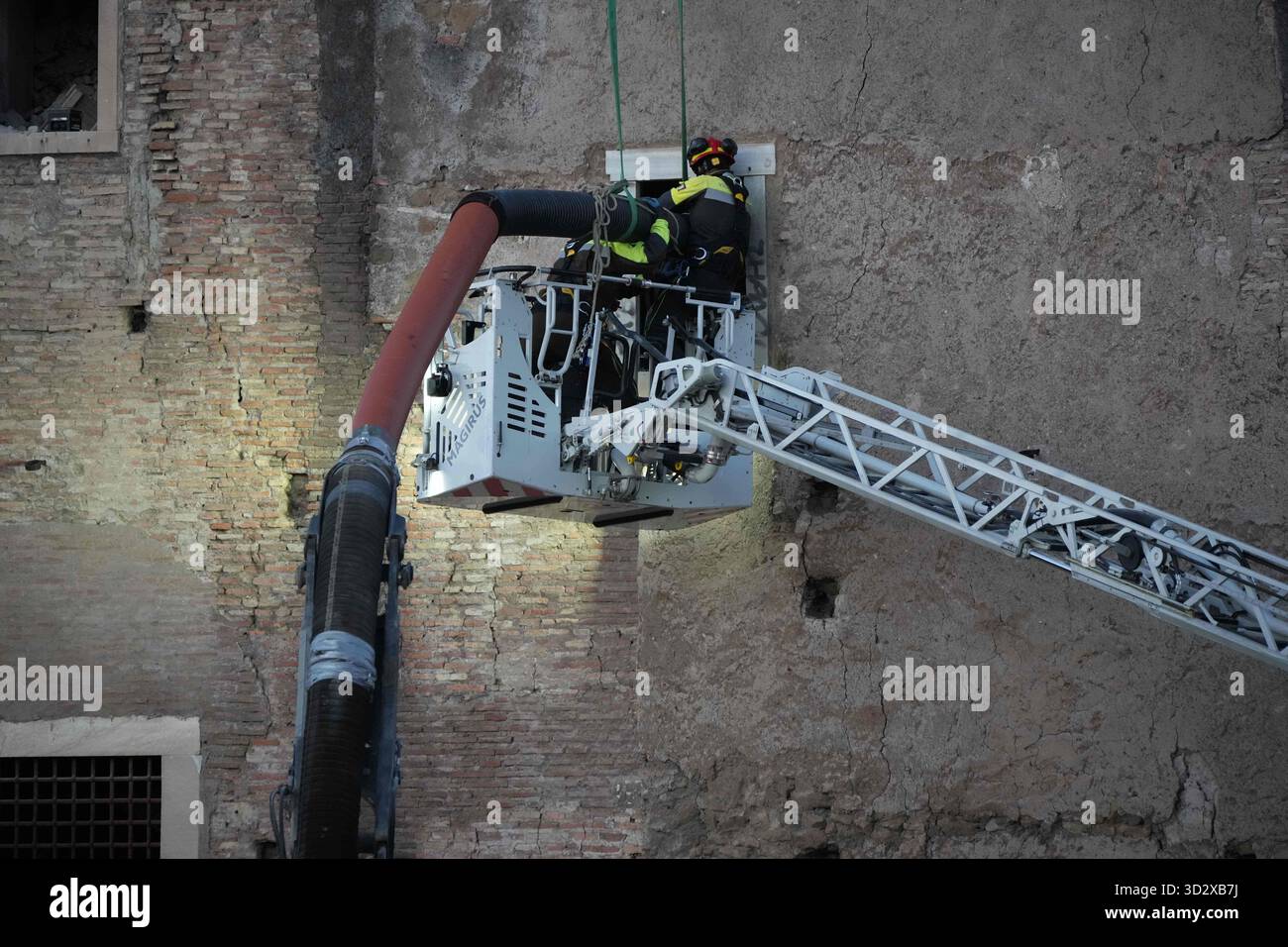 Firefighters work on a medieval tower Torre dei Conti near the Roman ...