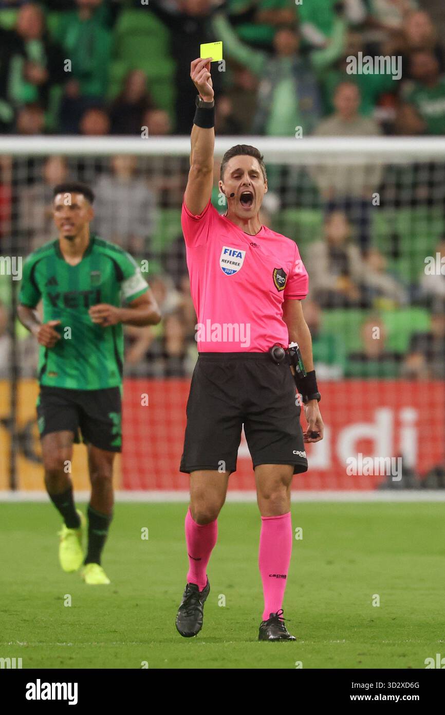 AUSTIN, TX - NOVEMBER 02: The referee yells and holds up a yellow card ...