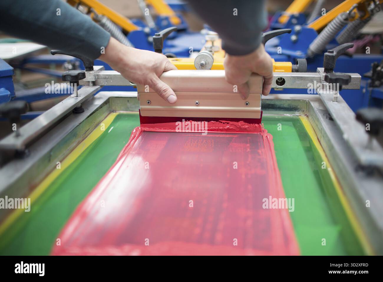 Silk screen printing. Serigraphy. Color paints and fabric. Plastisol ...