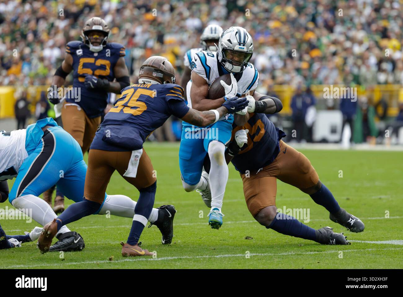 Carolina Panthers running back Chuba Hubbard (30) is hit by Green Bay Packers defensive tackle ...