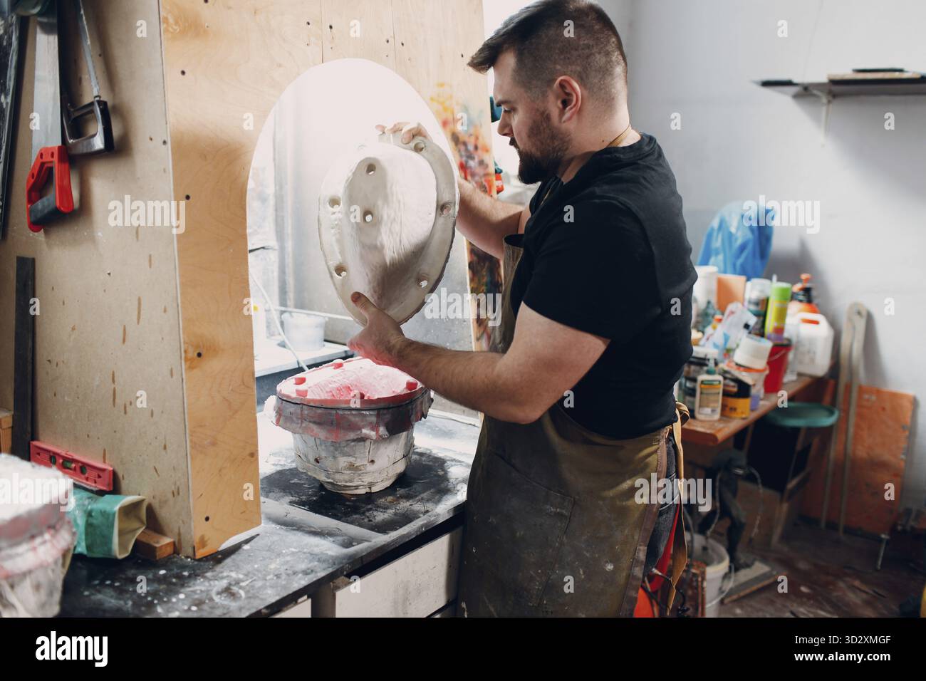 Artisan craftsman create mask based on plaster cast. Gypsum mold and ...