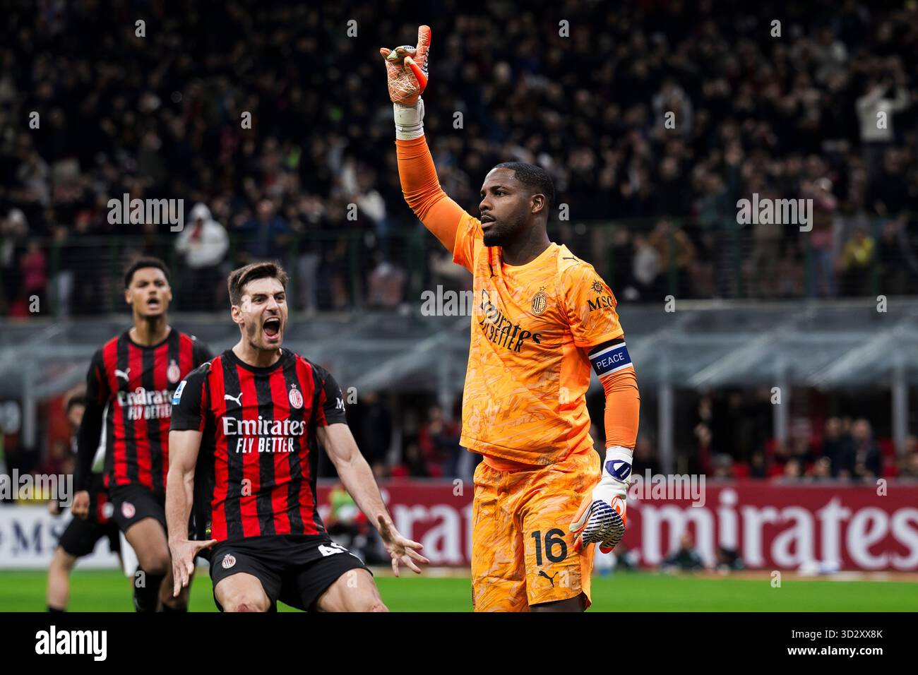 Mike Maignan of AC Milan celebrates after saving a penalty kick from ...