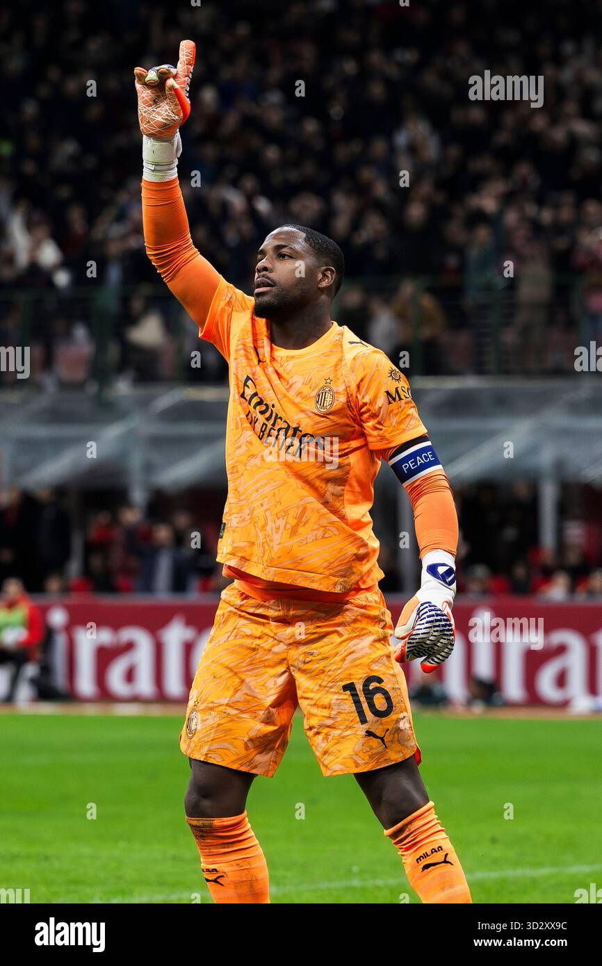 Mike Maignan of AC Milan celebrates after saving a penalty kick from ...
