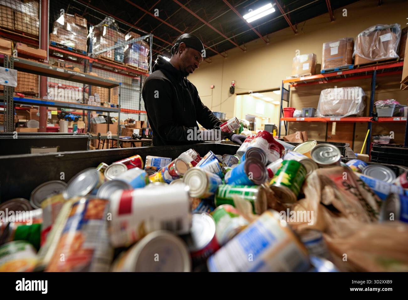 Volunteer Matthew Underwool works at MUST Ministries food distribution ...