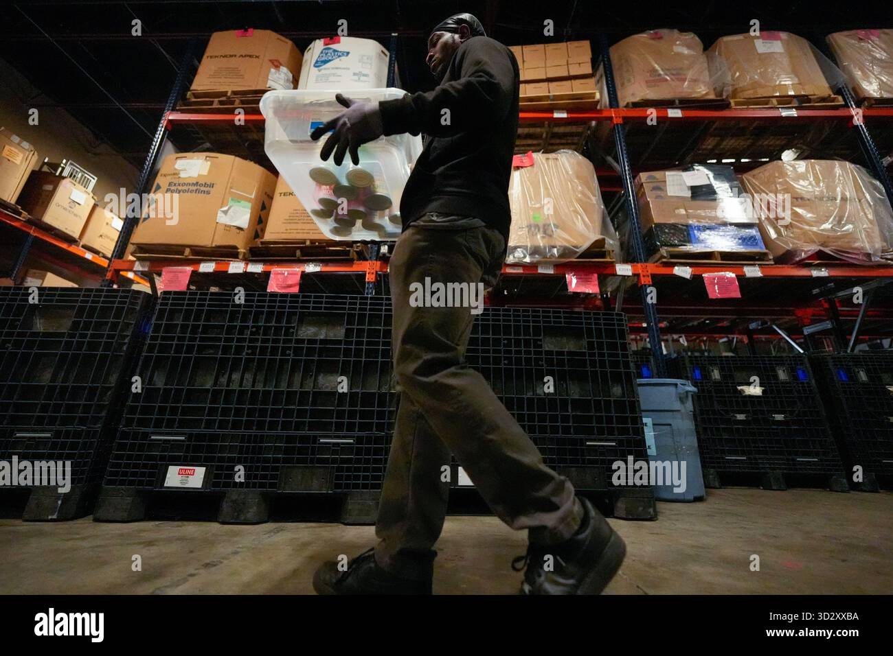 Volunteer Matthew Underwool works at MUST Ministries food distribution ...