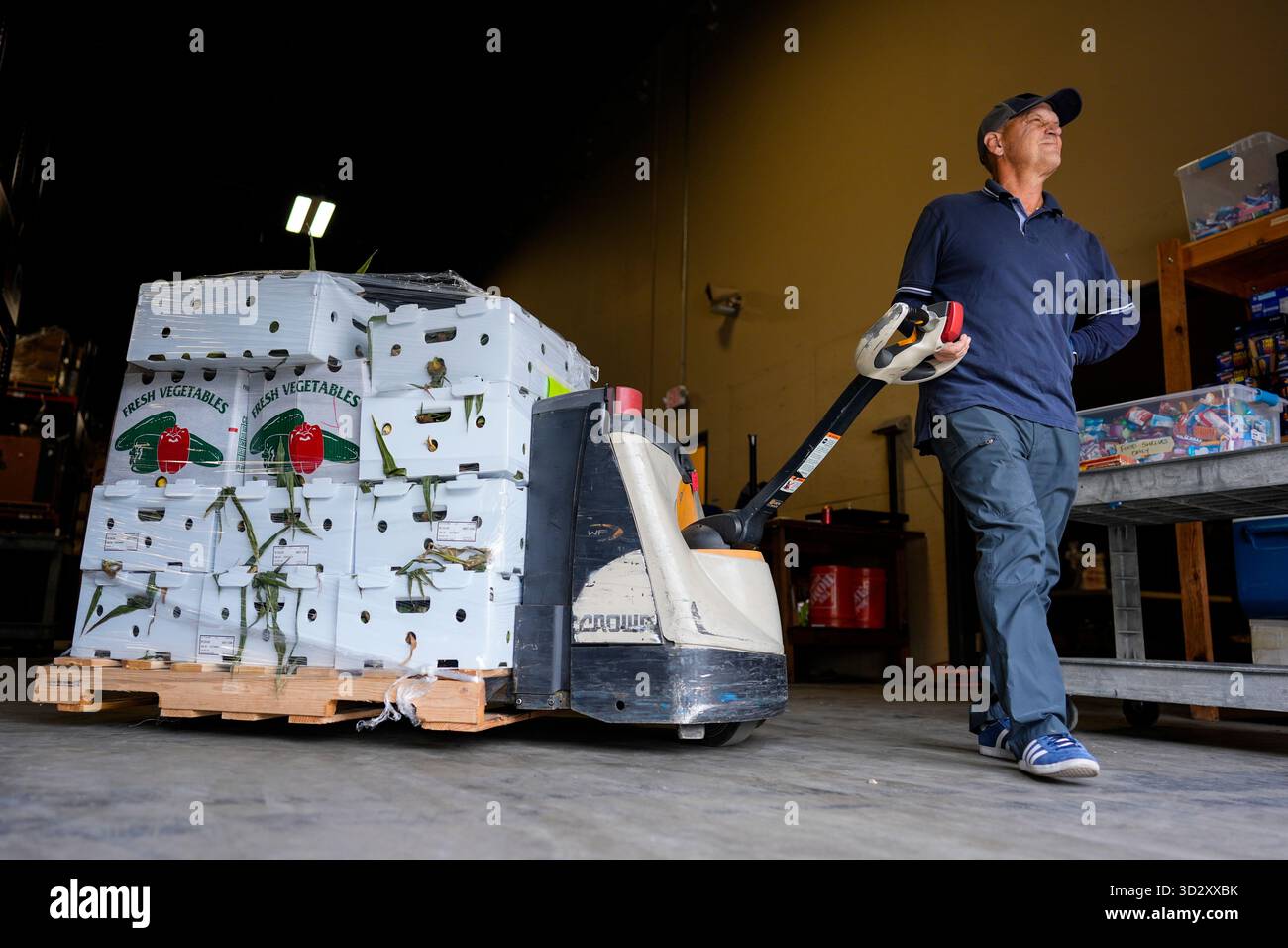 Volunteer Brian Perkins works at MUST Ministries food distribution ...