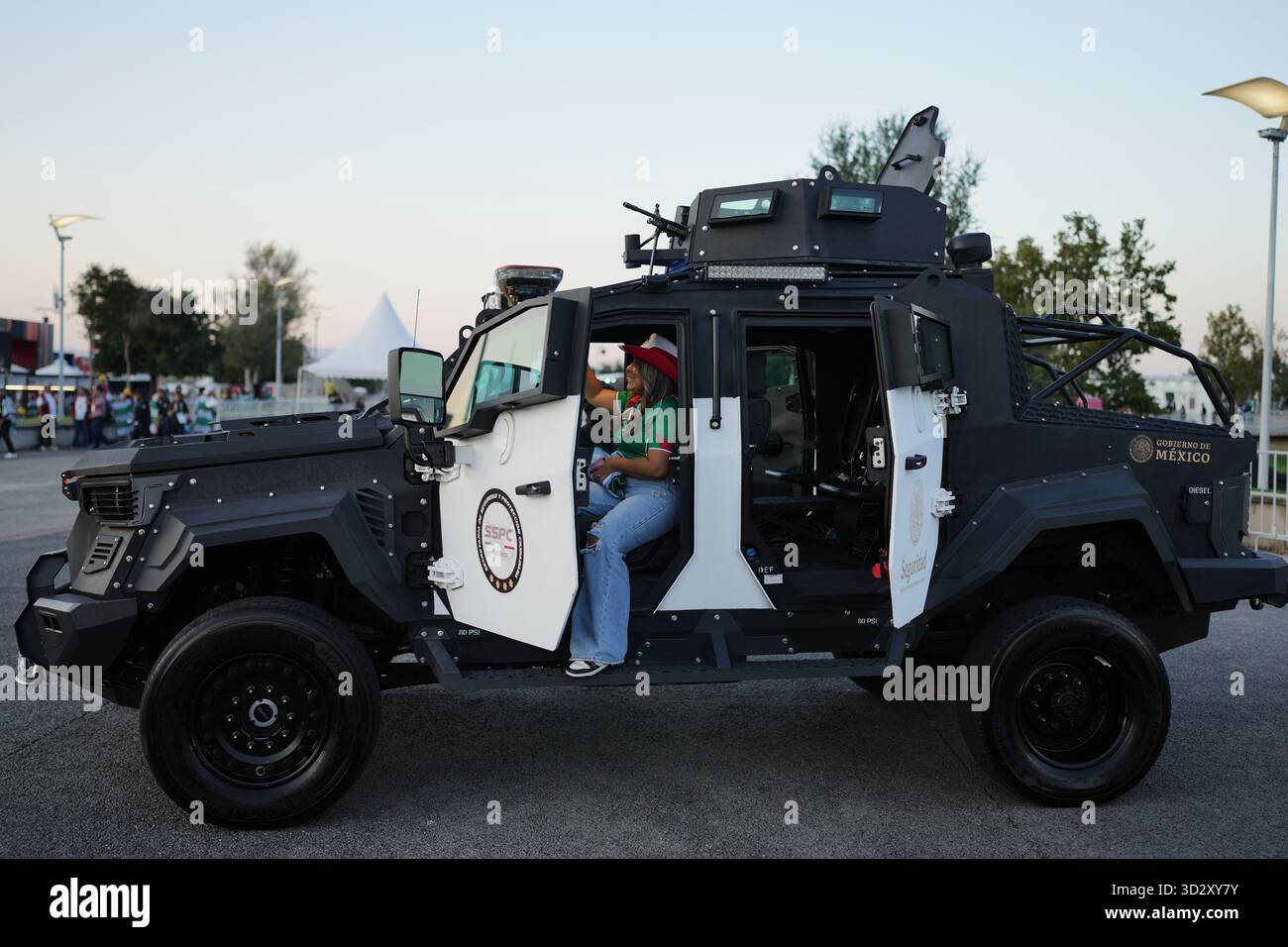 A fan sits in a police vehicle outside Akron Stadium prior to a ...